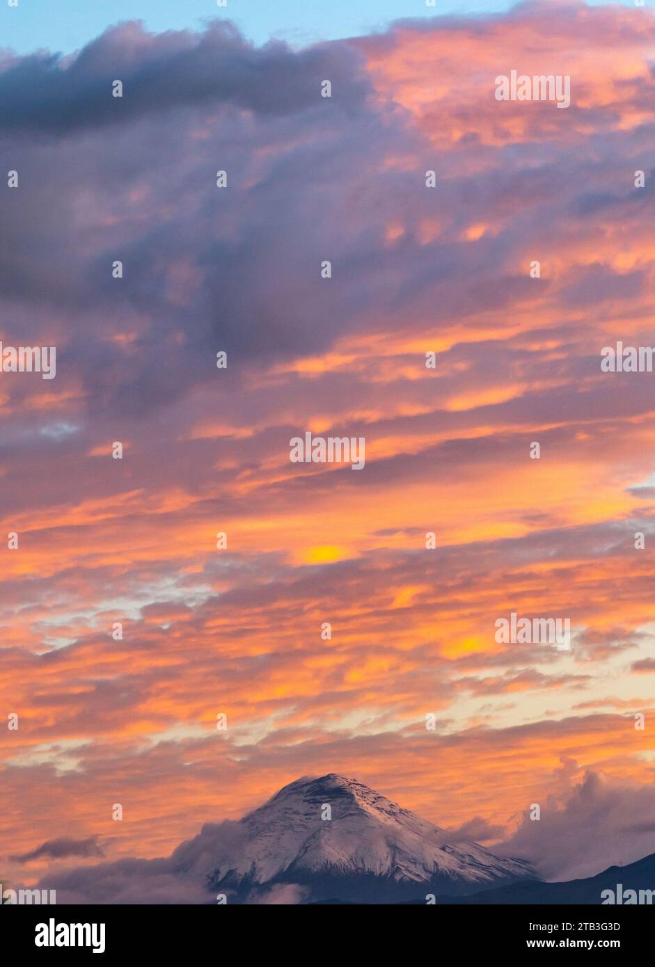 Cotopaxi volcano at sunset with clouds in blue and red tones seen from ...