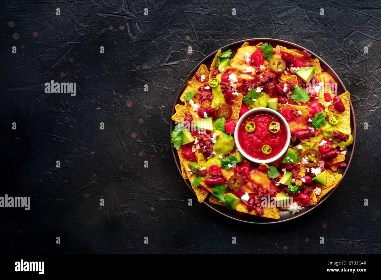 Loaded nachos. Mexican nacho chips with beef, overhead flat lay shot ...