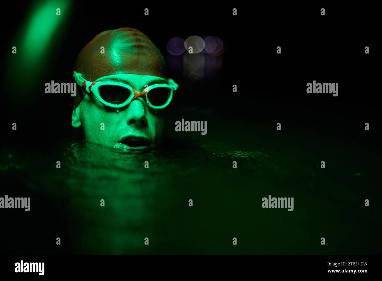 Authentic triathlete swimmer having a break during hard training on ...