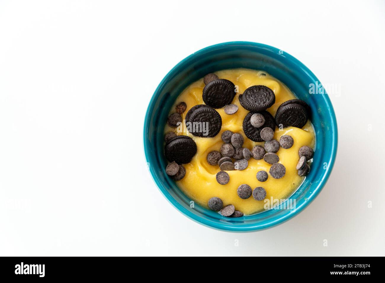a birds eye view of a mango acai bowl topped with chocolate chips and ...