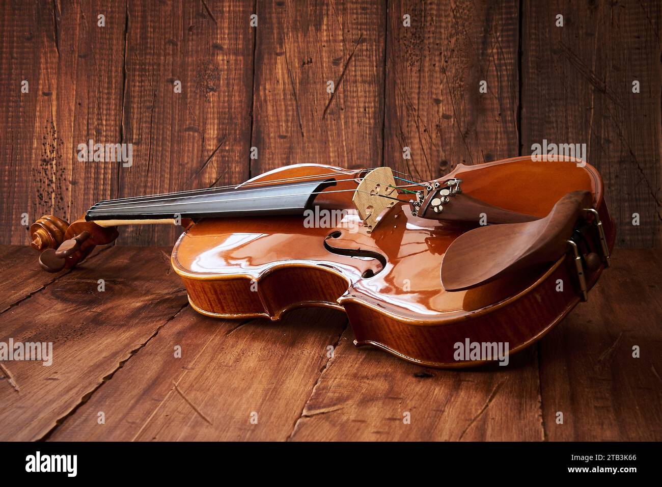 Violin, beautiful musical instrument on a rustic wooden background ...