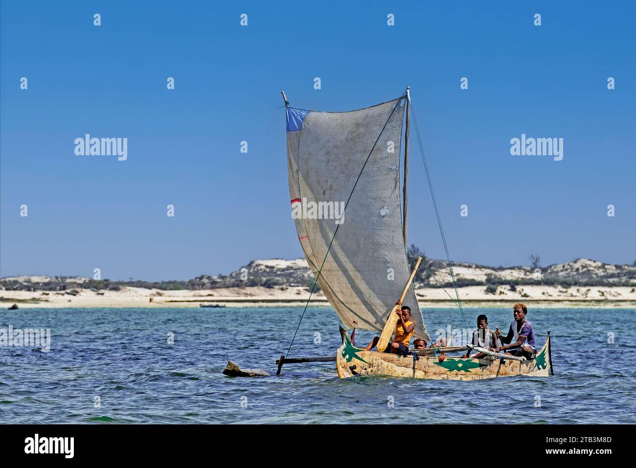 Malagasy fishermen sailing in traditional wooden fishing boat ...
