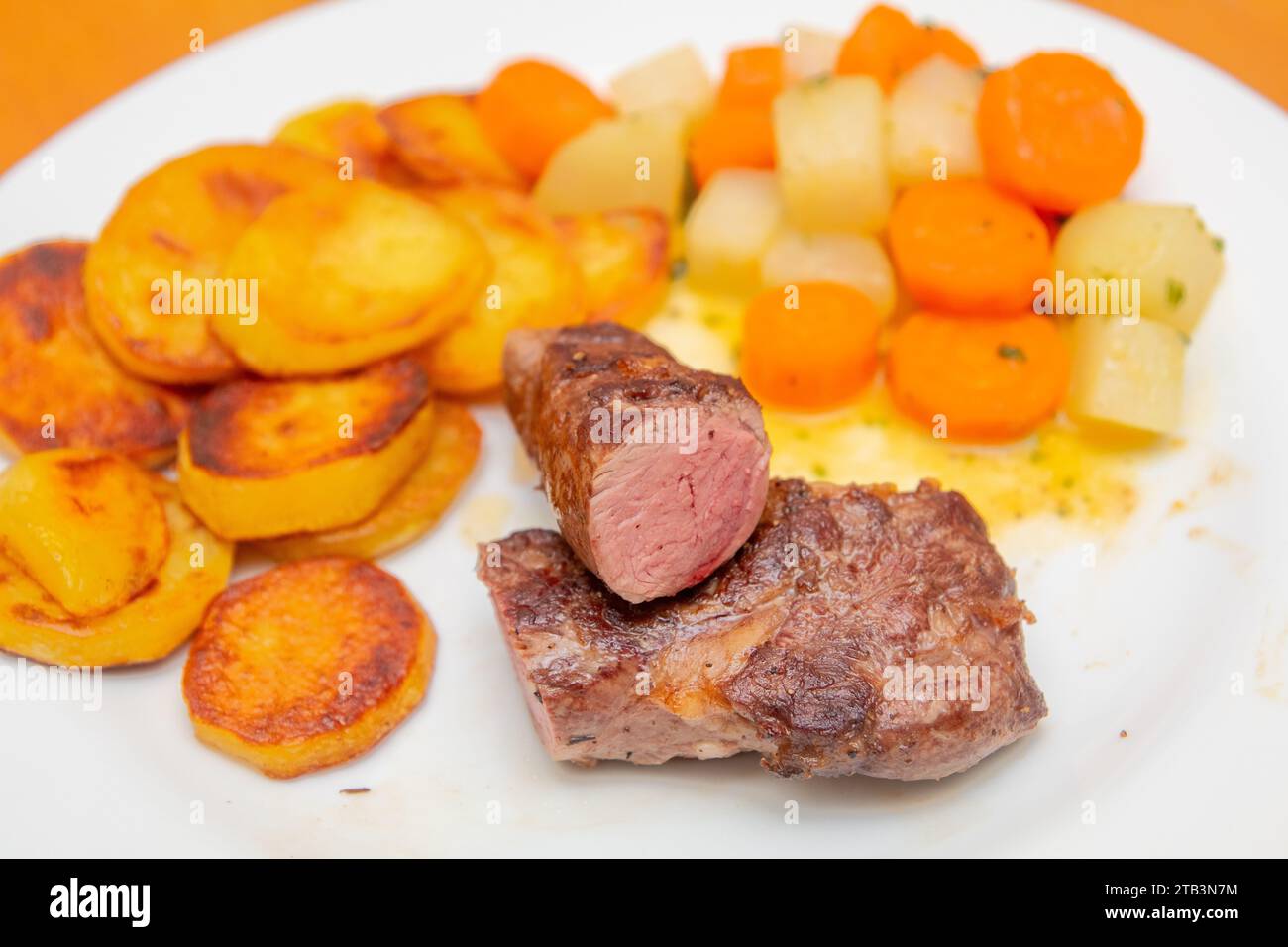 Wild boar loin (young wild boar loin) with fried potatoes and root ...