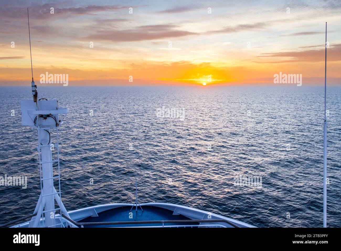 Beautiful Orange Sunset in the Ocean captured from a ferry deck between ...
