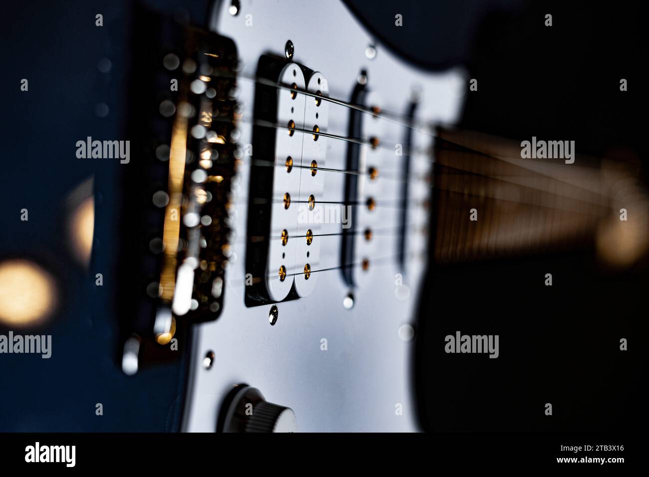 Blue electric guitar with reflections of stage spotlights in private ...