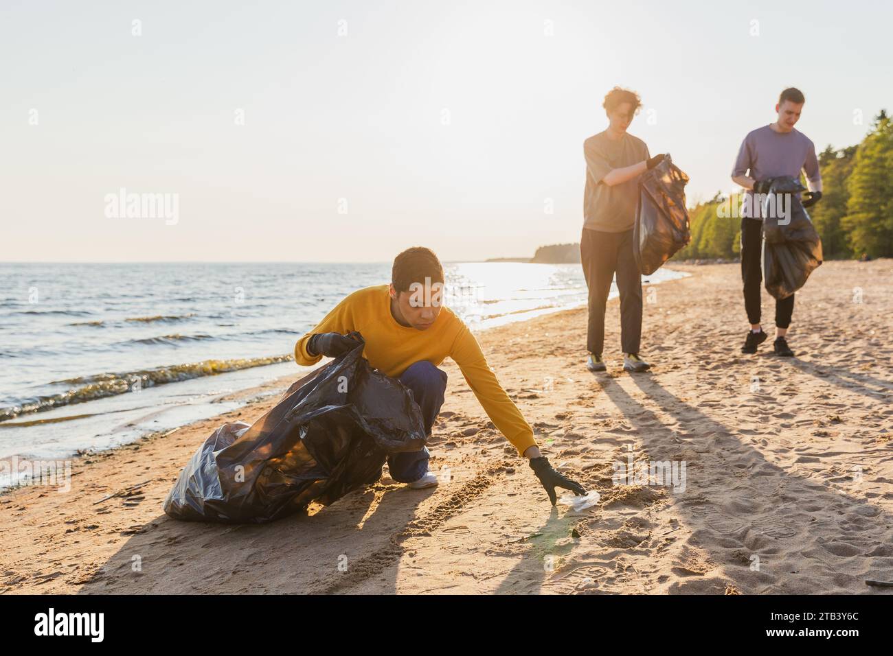 Earth day. Volunteers activists team collects garbage cleaning of beach ...