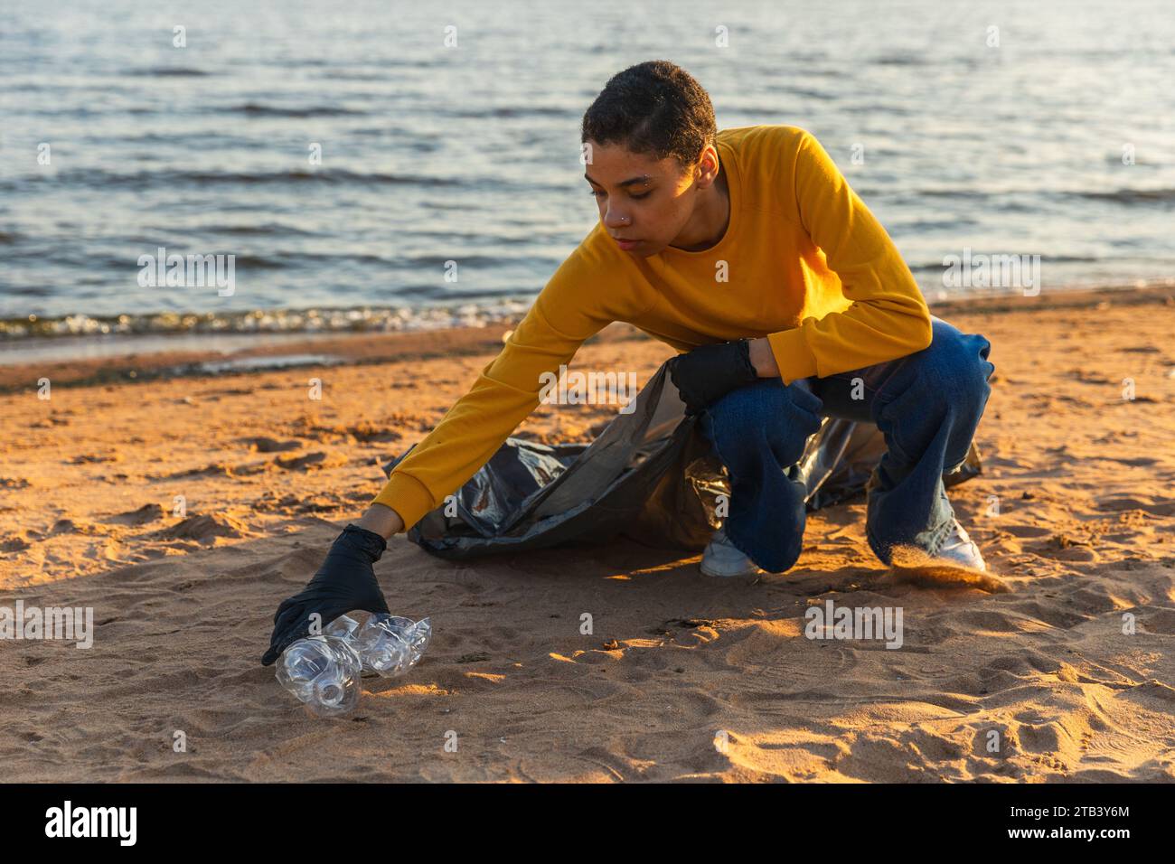 Earth day. Volunteers activists team collects garbage cleaning of beach ...