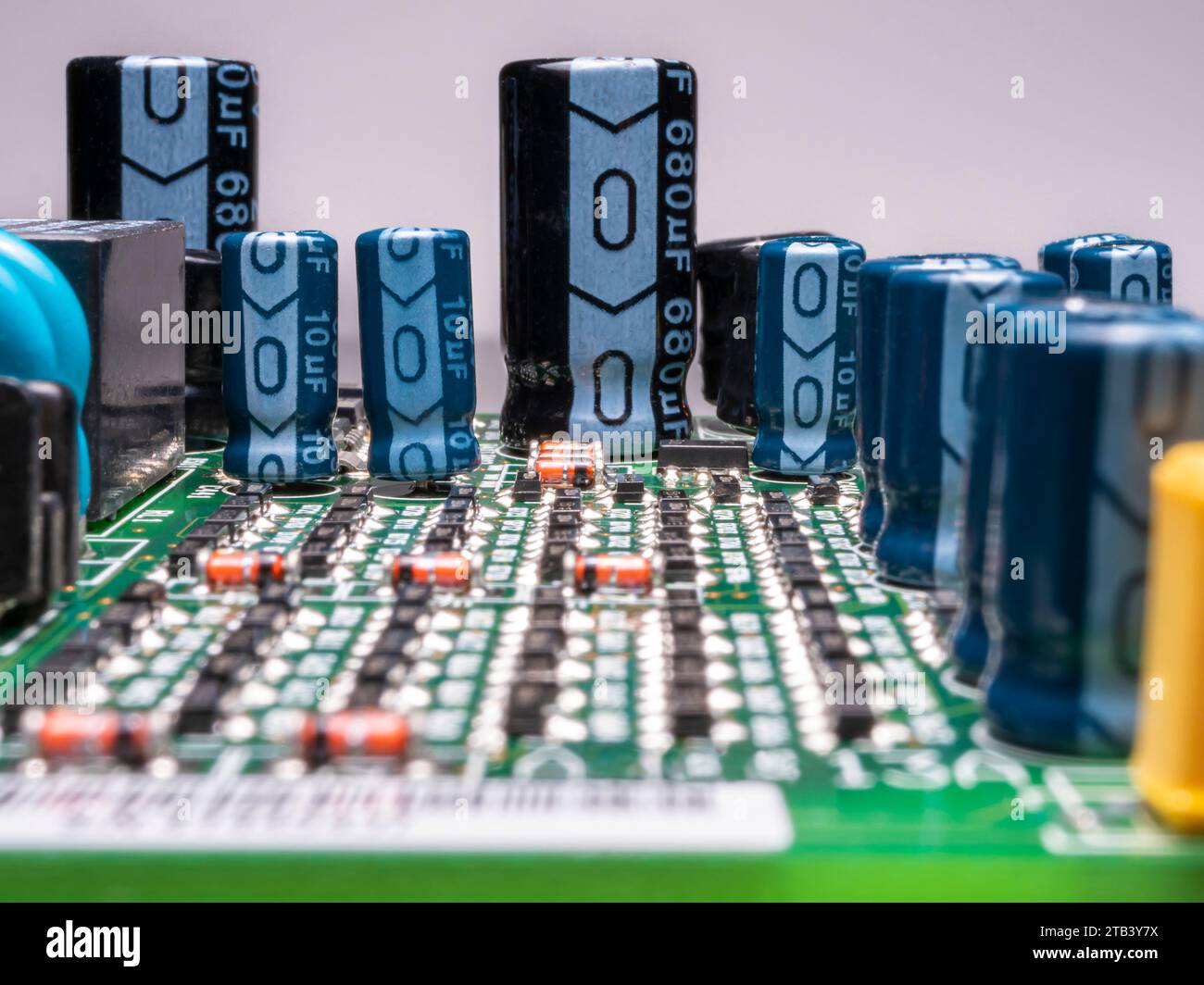 Green printed circuit board with electronic components. Selective focus ...