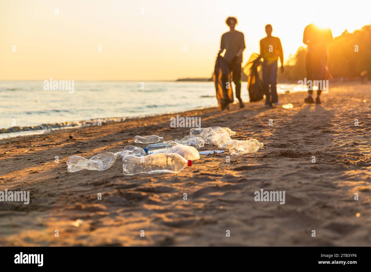 Earth day. Volunteers activists team collects garbage cleaning of beach ...