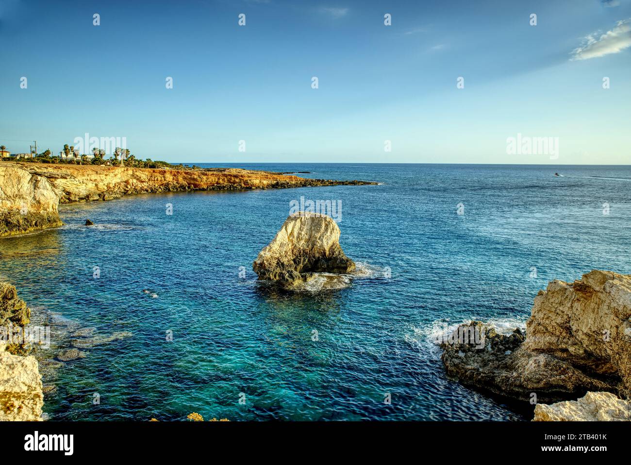 Sea caves en beautifful rocky Cypriot coast, brightly blue water, sunny ...