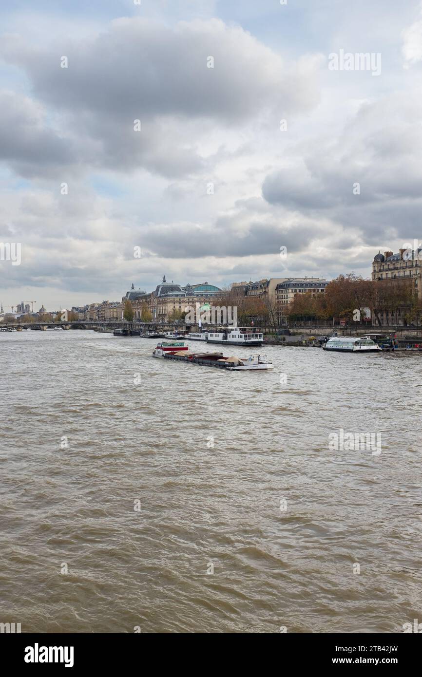 Paris, France, 2023. A barge sailing downstream on the Seine as seen ...
