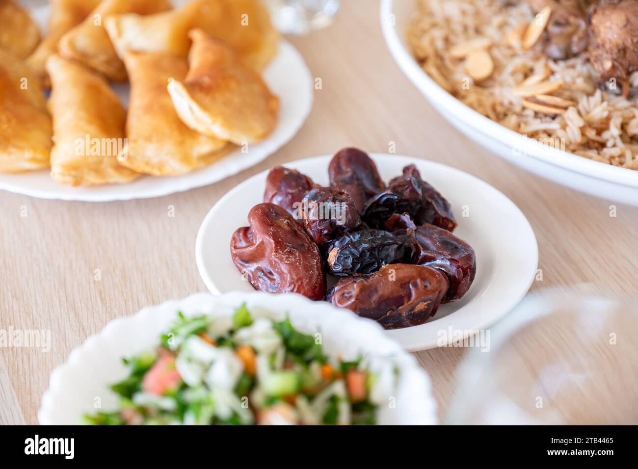 Dates on dining table served with rice and water for iftar with arabian ...
