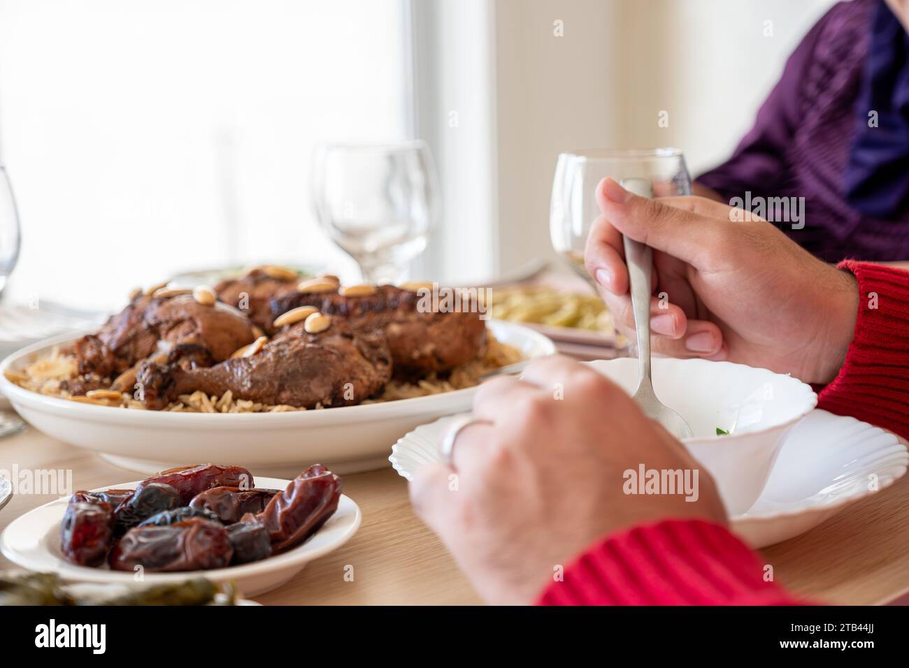 human hands while eating with family Stock Photo - Alamy