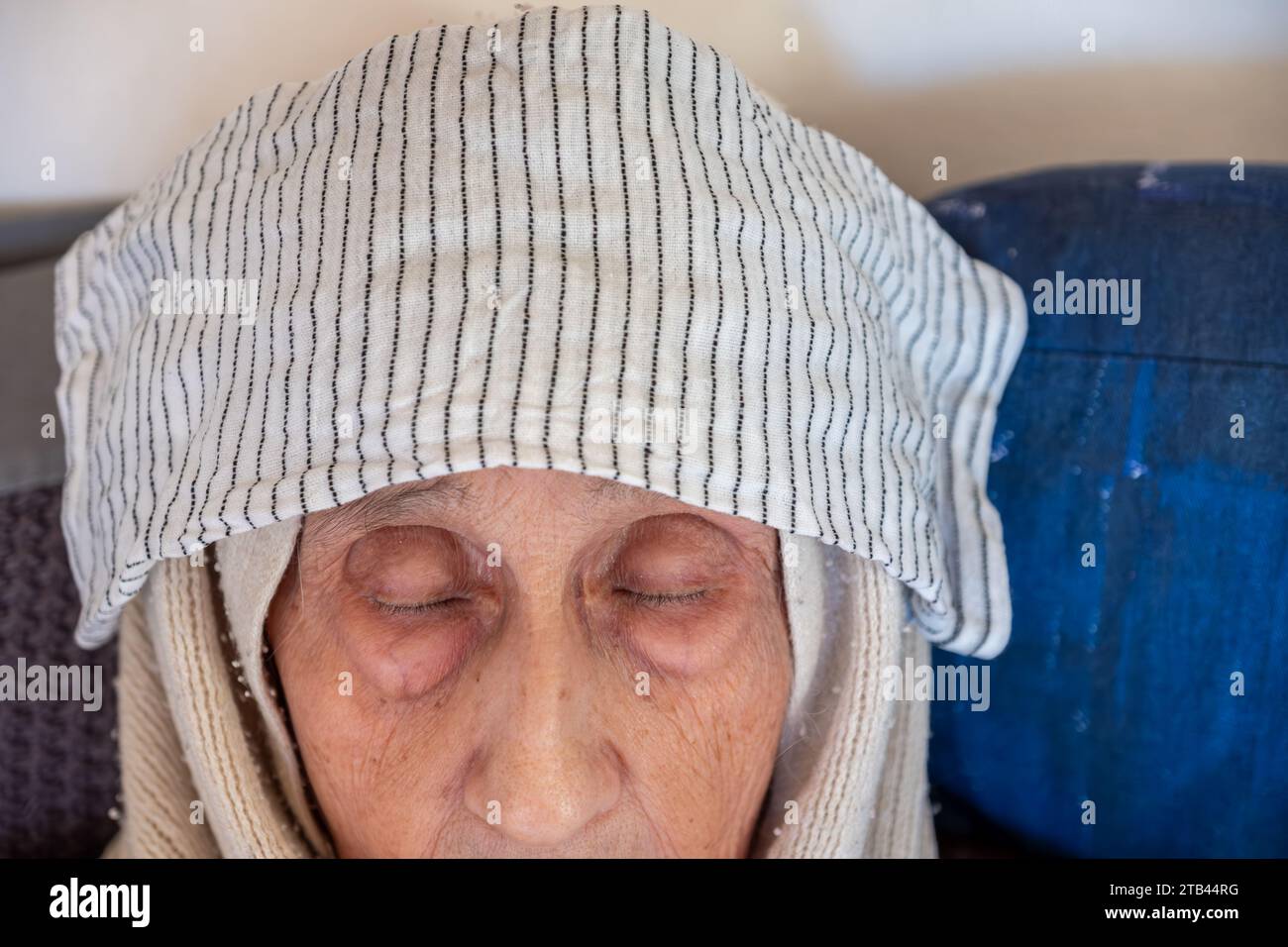 Old lady using wet towel to stop headache and high body temperature ...