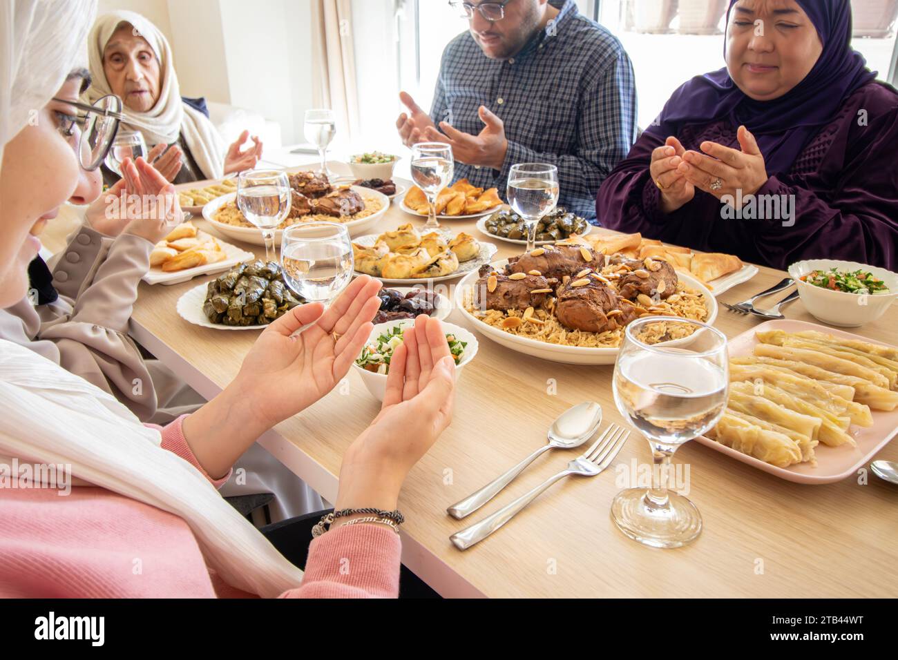 Family eating together with multi generation members in modern living ...