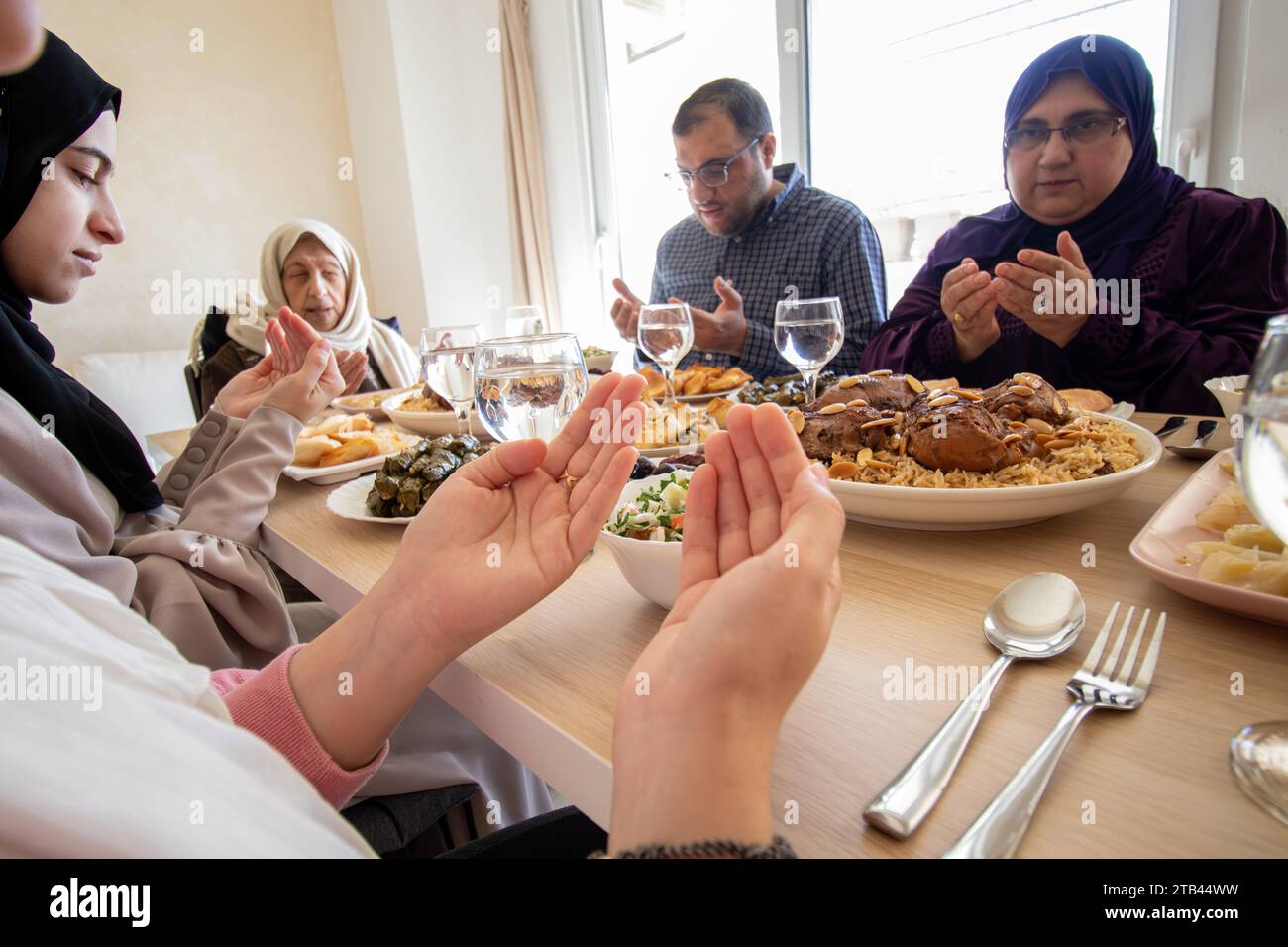 Family eating together with multi generation members in modern living ...