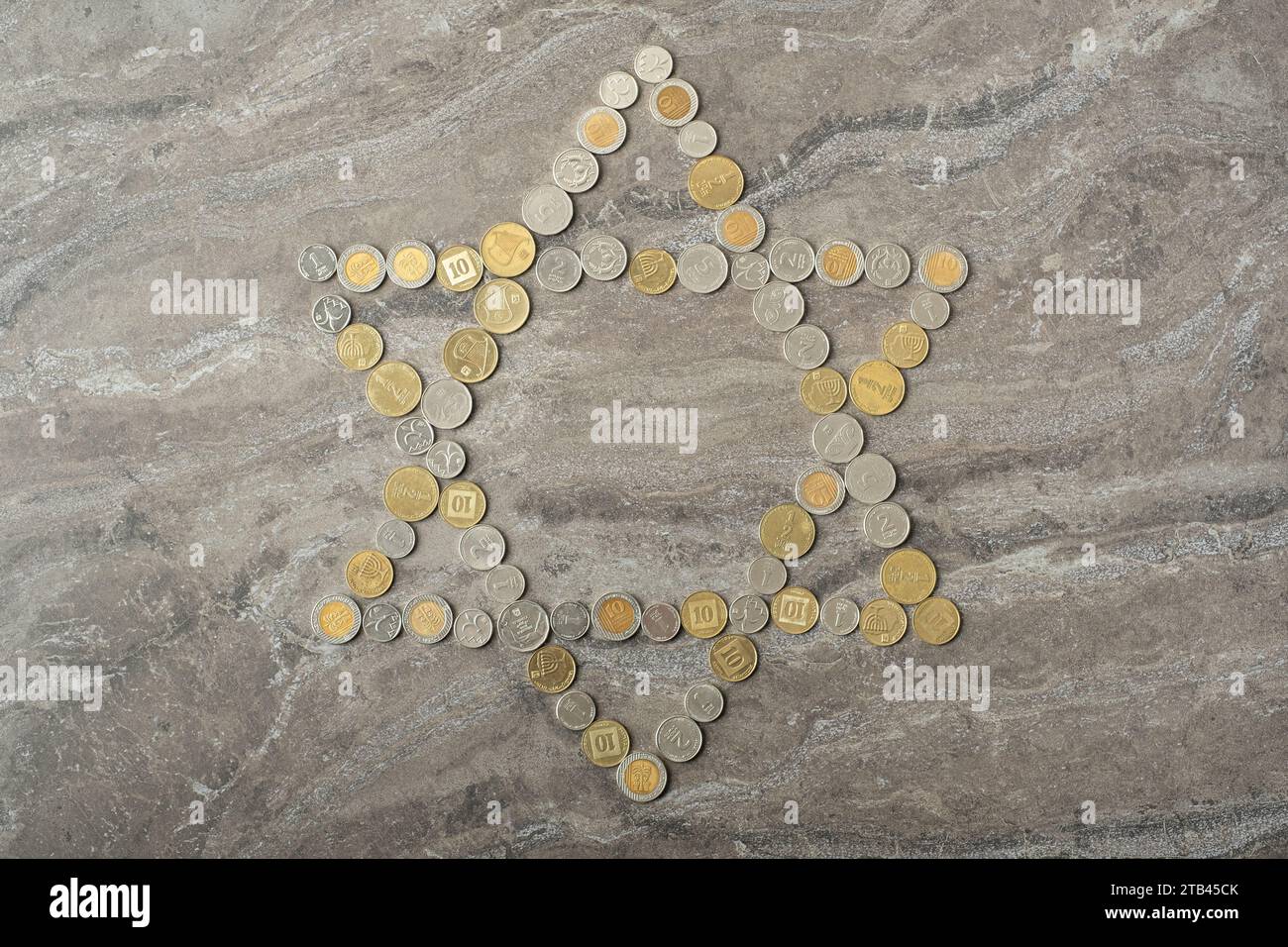 Israel's new shekel (NIS) coins arranged to form the shape of the Magen ...