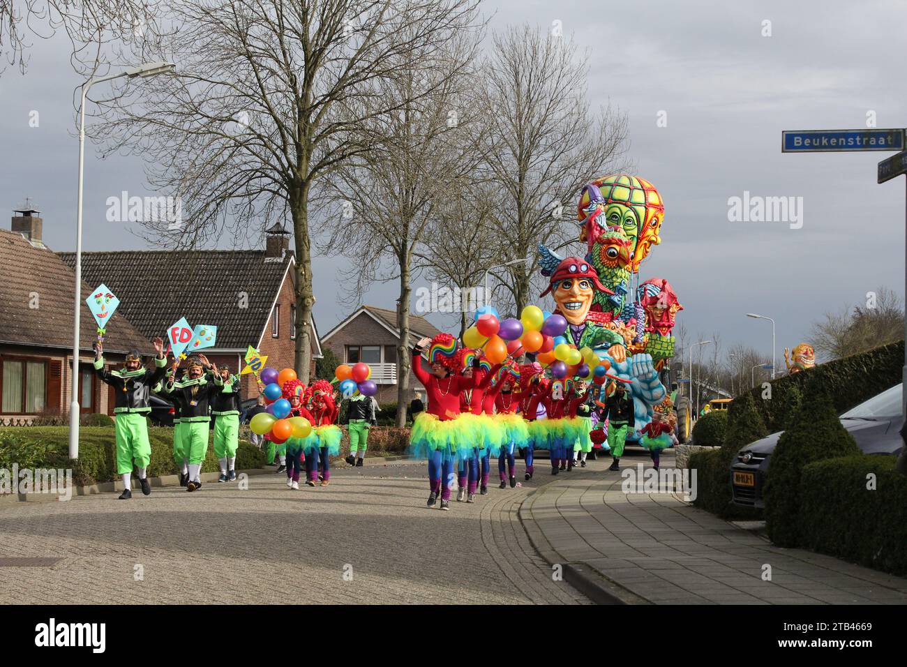 a carnival group with colorful rainbow costumes and a big float in the ...