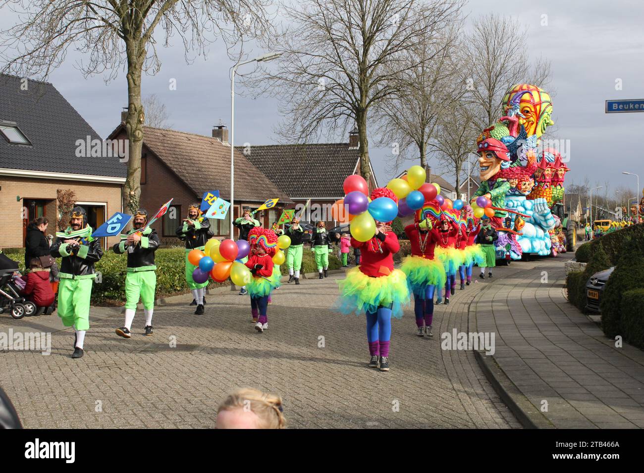 a beautiful big float and a large group of people in colorful costumes ...