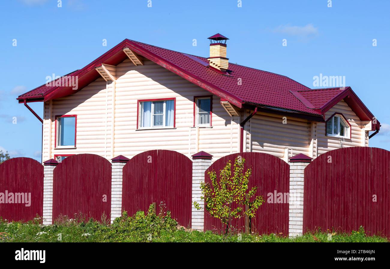 Construction of new wooden country house with a roof from metal profile ...