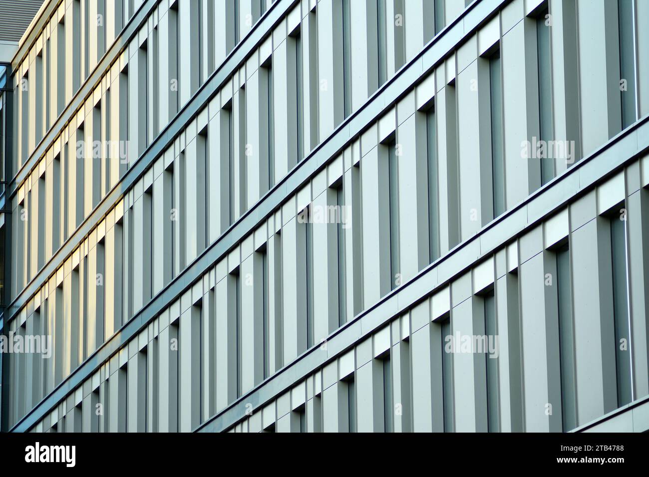 Modern office building with white metallic panel facade and windows ...