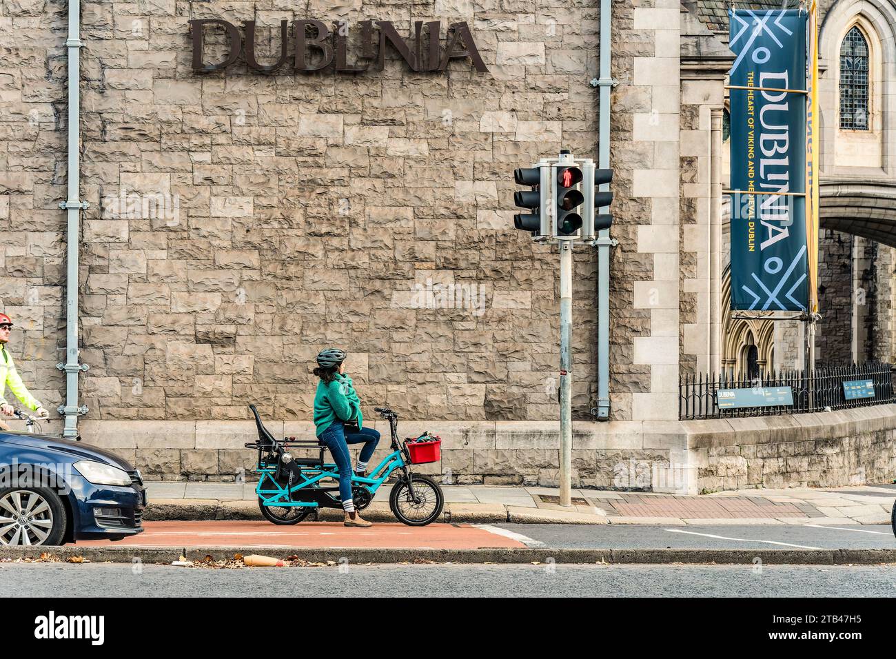 Lady cyclist waiting for a traffic light in front of Dublinia - Viking ...