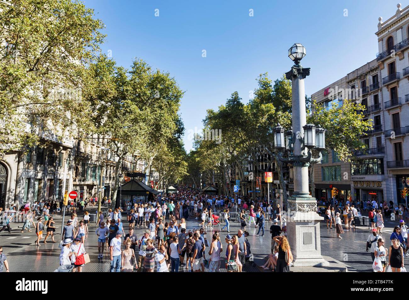Crowd in summer, pedestrians and tourists in pedestrian zone La Rambla ...