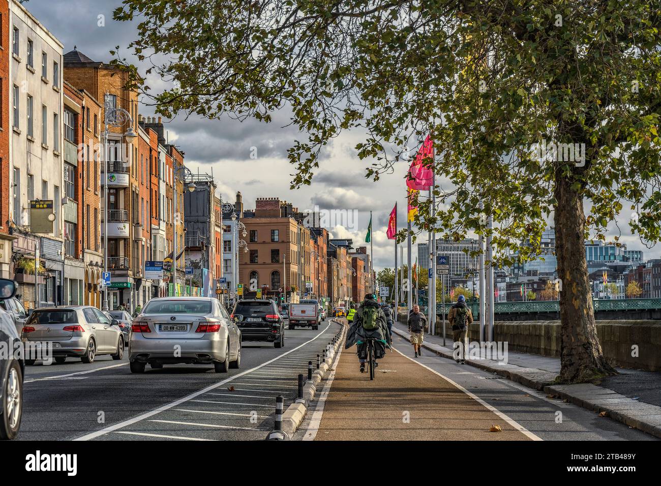 Cycle traffic lane at Dublin’s quays along the Liffey River separated ...