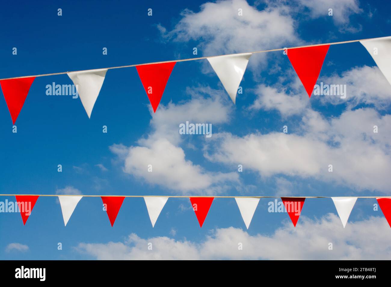 Colorful triangle bunting flags of various colors as festival concep ...