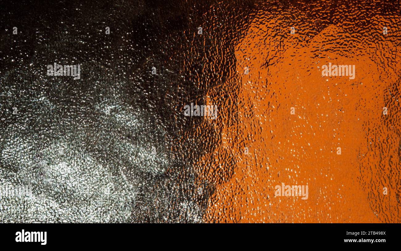 Light reflections on a pane of glass, abstract black and white orange ...