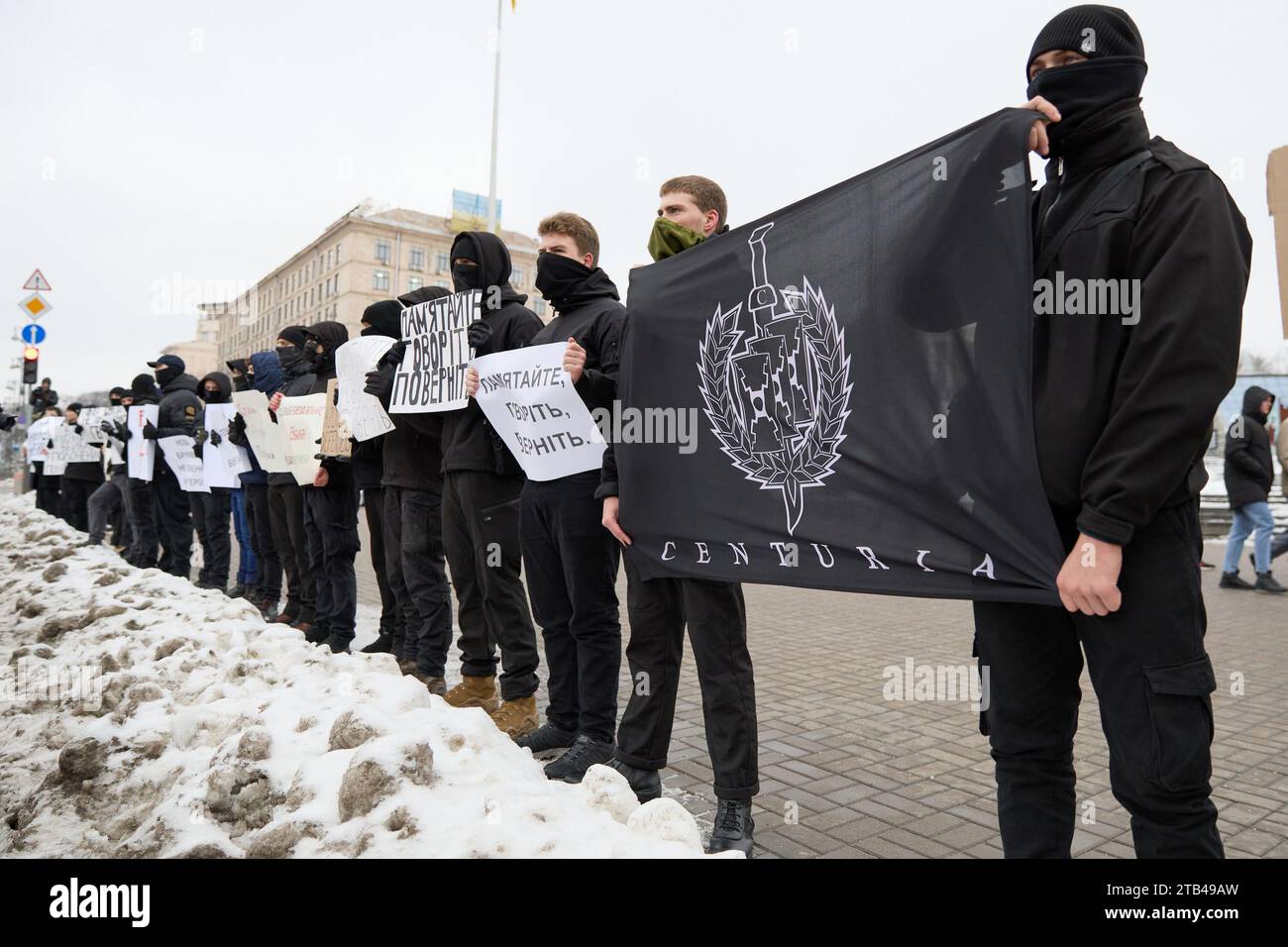 Young people holding a flag of Centuria, Ukrainian nationalist ...
