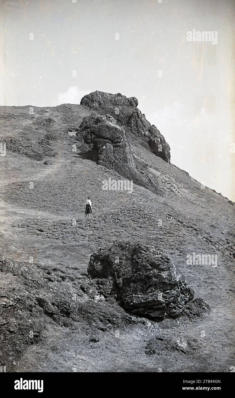 1950s, historical, a lady on a hillside inbetween a number of ancient ...