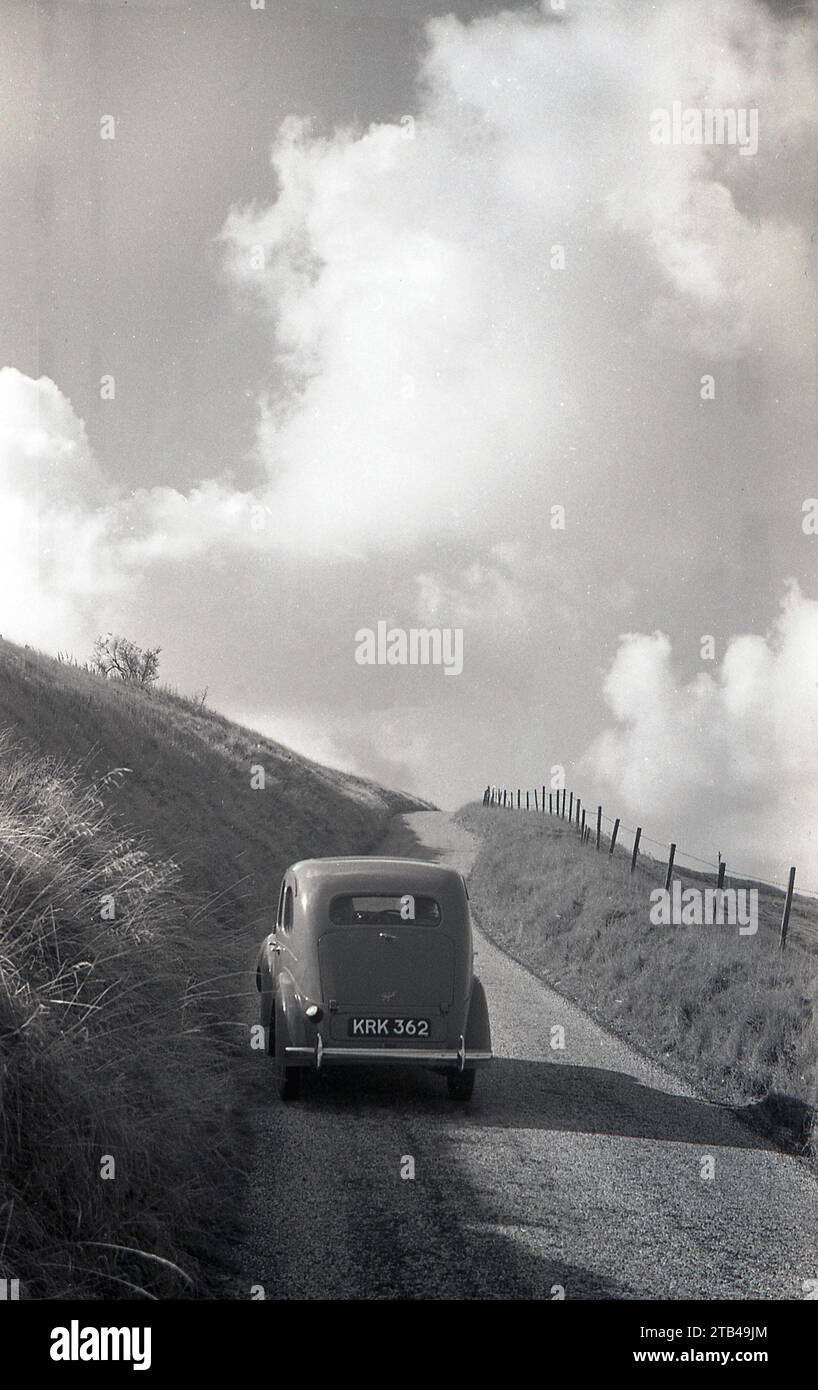 1950s, historical, a mototcar of the era, possibly an Austin, parked on ...