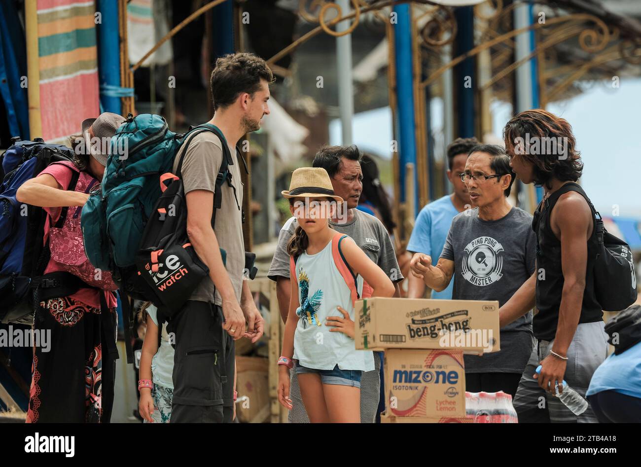 Travellers with backpacks seeking ferry info in the port of this ...
