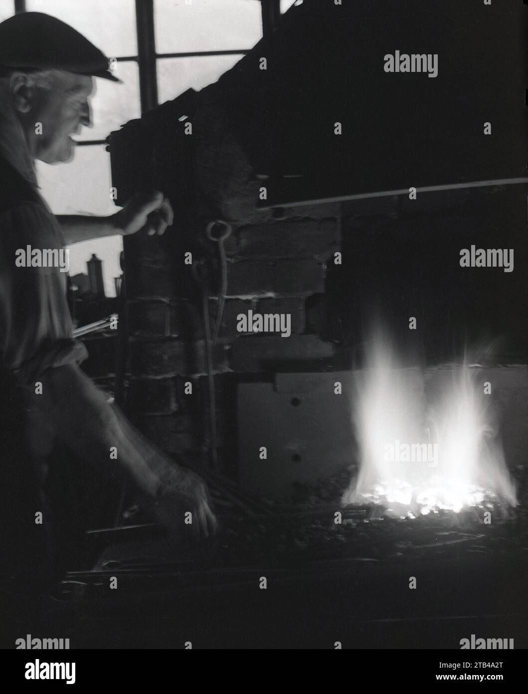 1970s, historical, a farrier working at a forge, England, UK. A ...