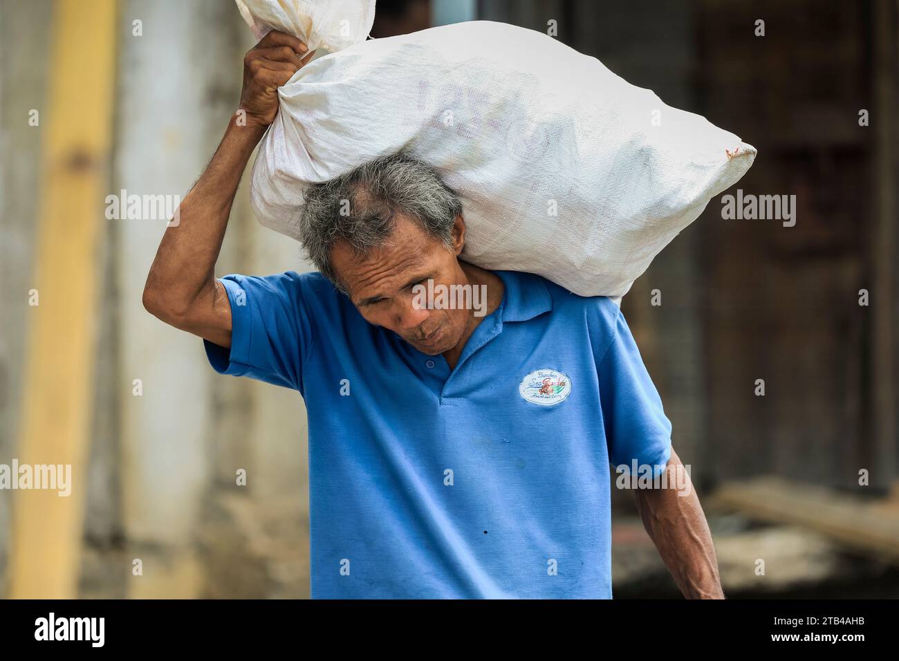 Man carrying sack of goods at the ferry wharf in the port of this ...