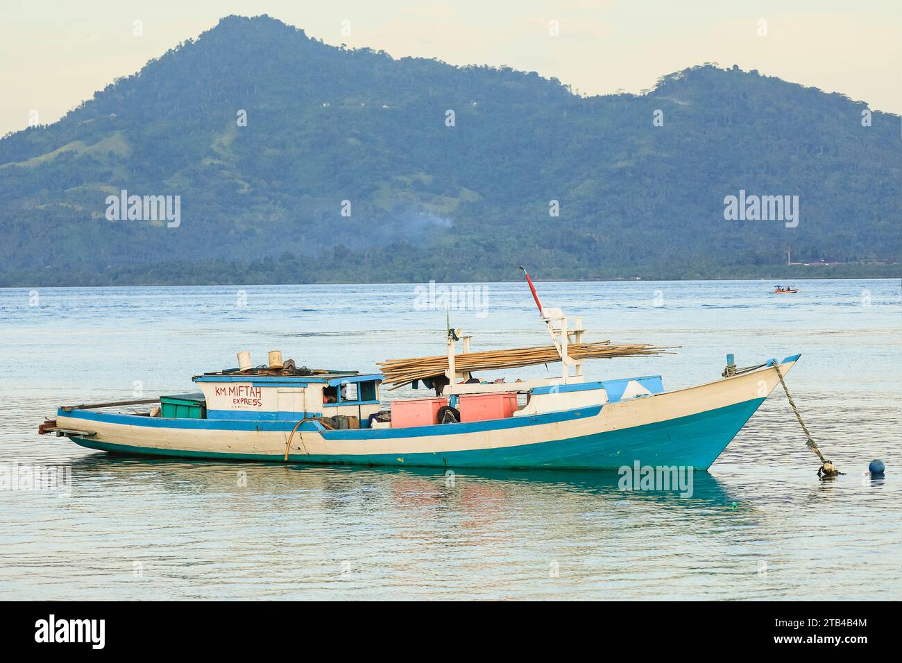 Fishing boat & view to the mainland & Gunung Tumpa at an eastern beach ...