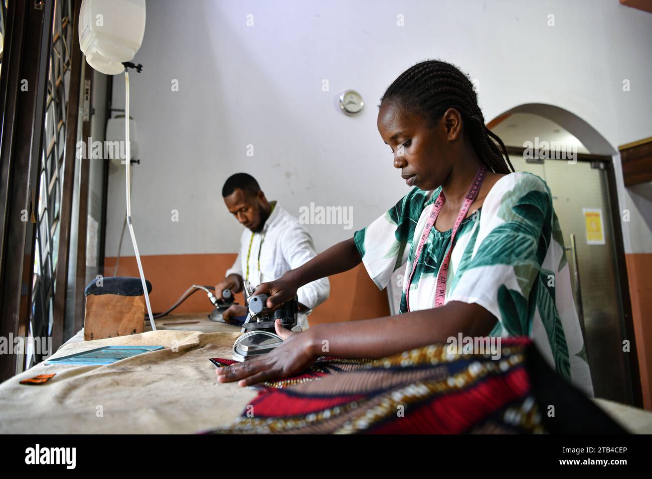 Nairobi, Kenya. 4th Dec, 2023. Tailors iron fabric during Africa ...