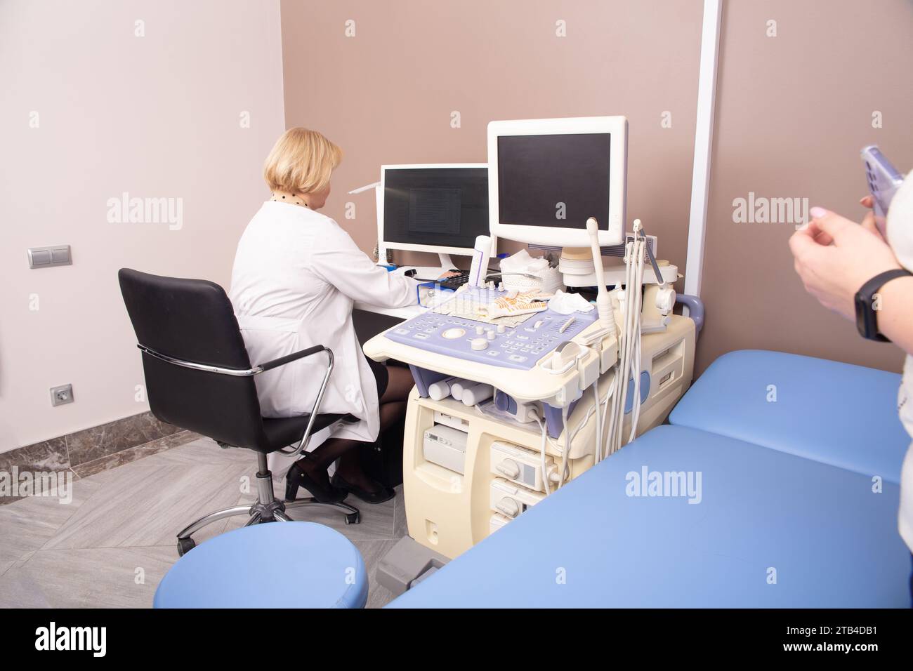 Rear view of medical doctor using ultrasound machine at hospital Stock ...