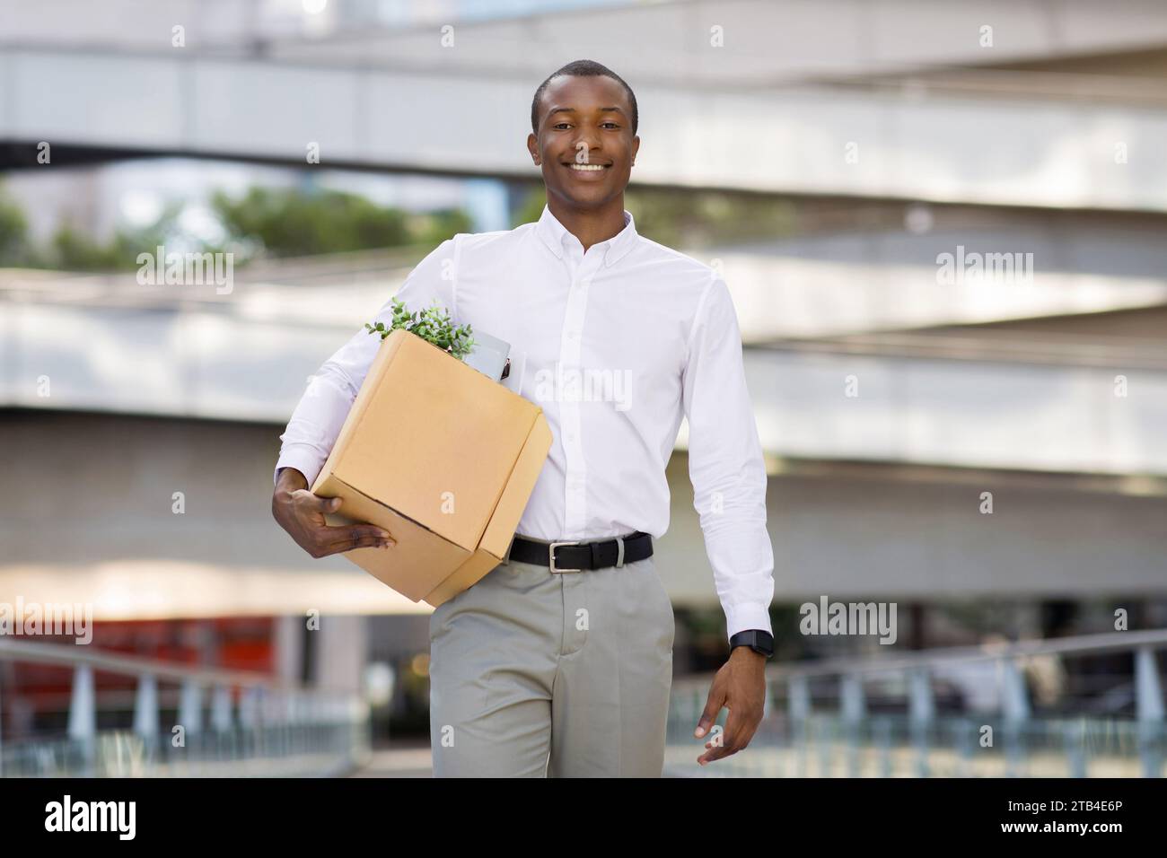 Happy Black Man Carrying Box With Personal Belongings While Walking ...