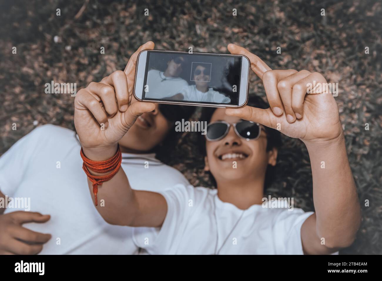Two friends taking a photo Stock Photo - Alamy