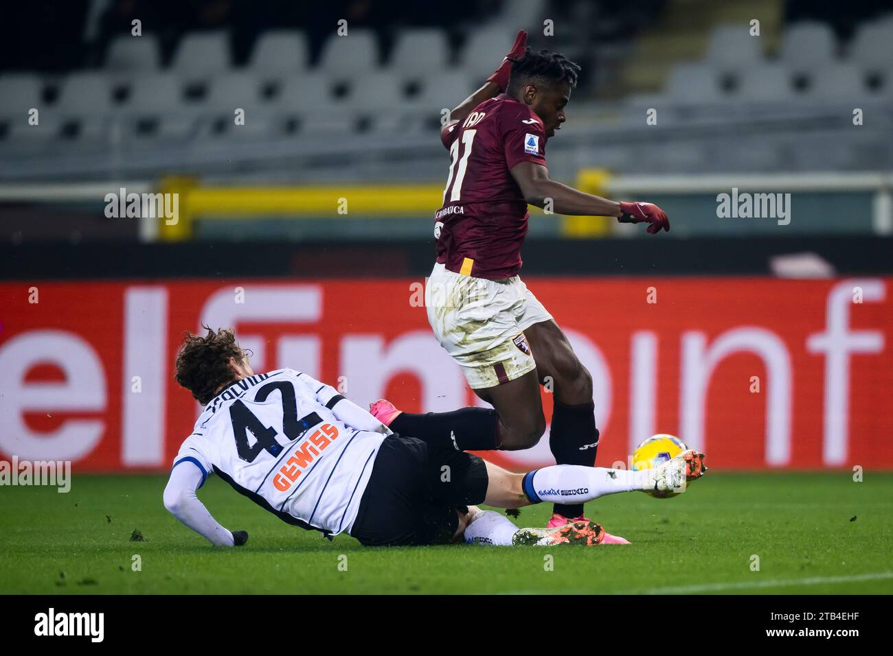 Turin, Italy. 4 December 2023. Duvan Zapata of Torino FC i tackled by ...