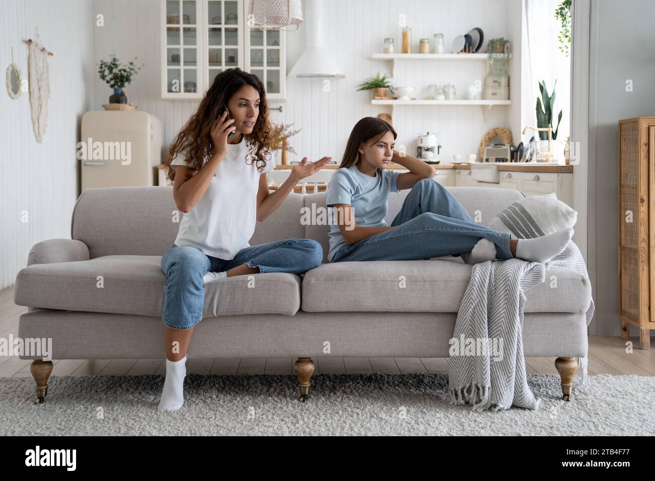 Emotional anxious young woman mother swearing by phone in front of ...