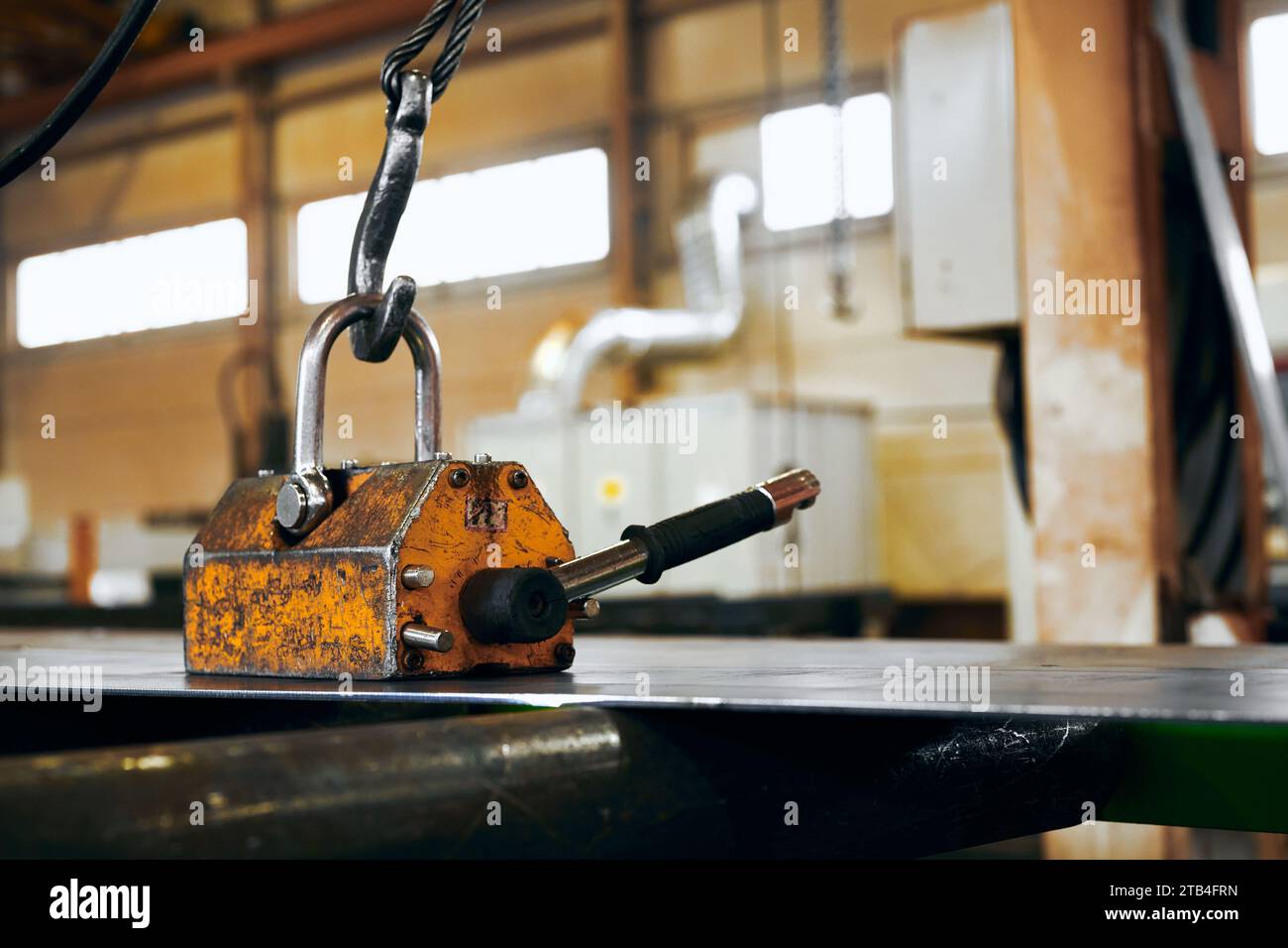 Magnetic grab to transport metal sheets in workshop Stock Photo - Alamy