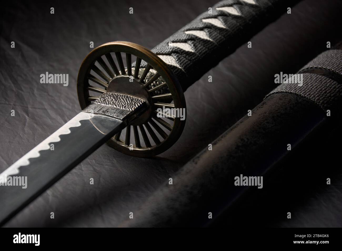 Horizontal photo of unsheathed katana with details of the handle and ...