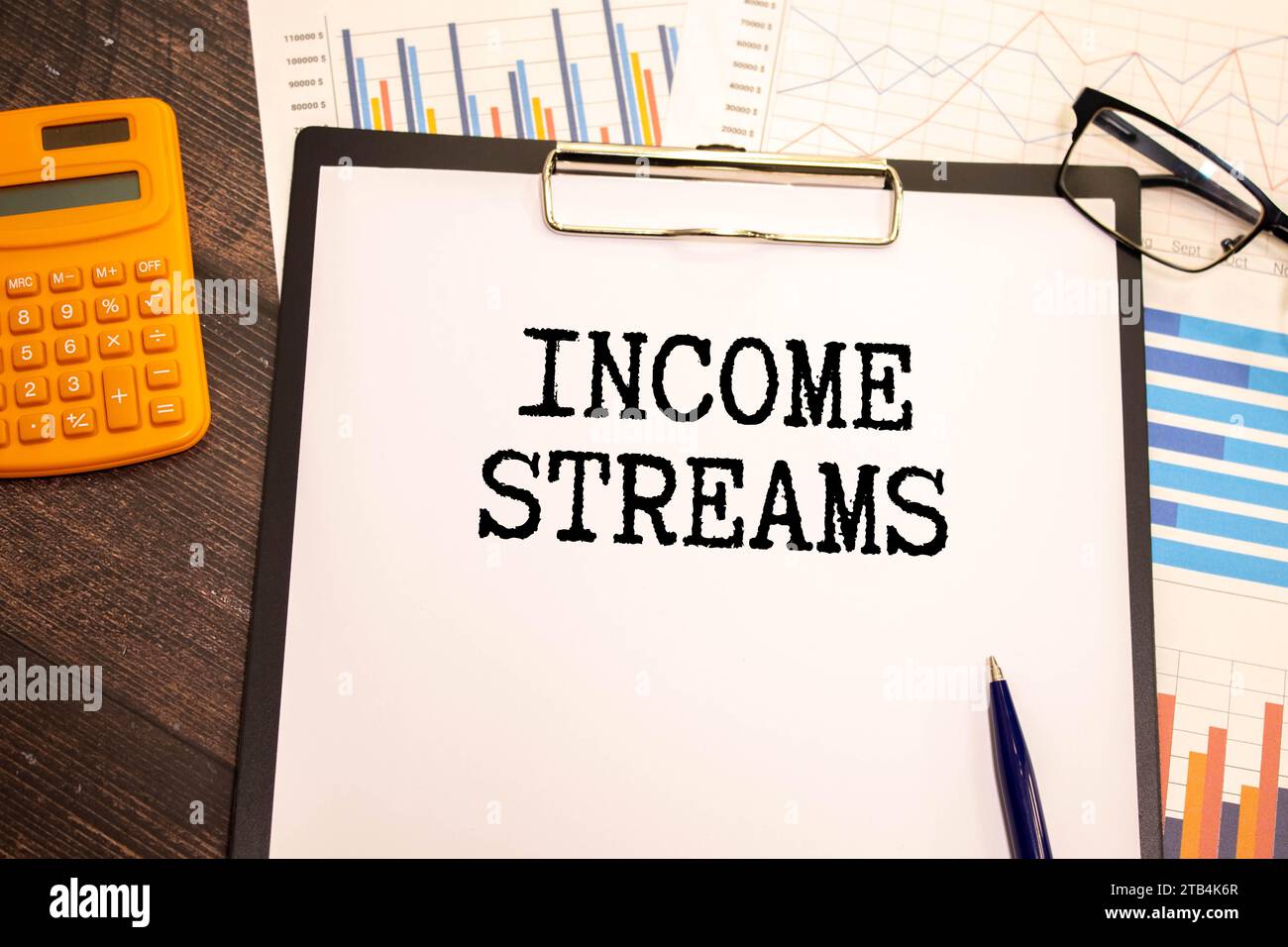 INCOME STREAMS text written on the white background with keyboard ...