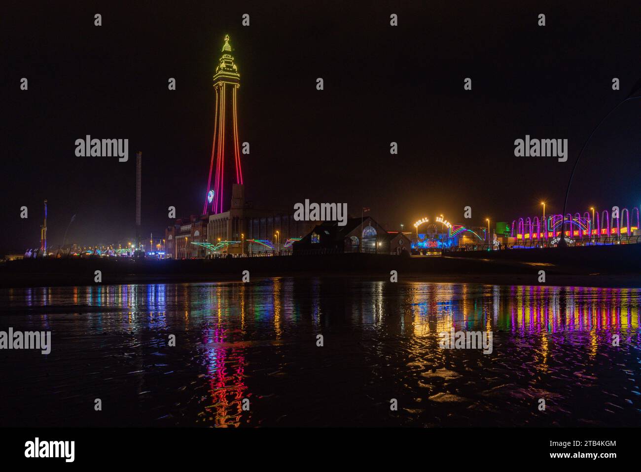 Blackpool Tower, sea front, beach and promenade at night with ...