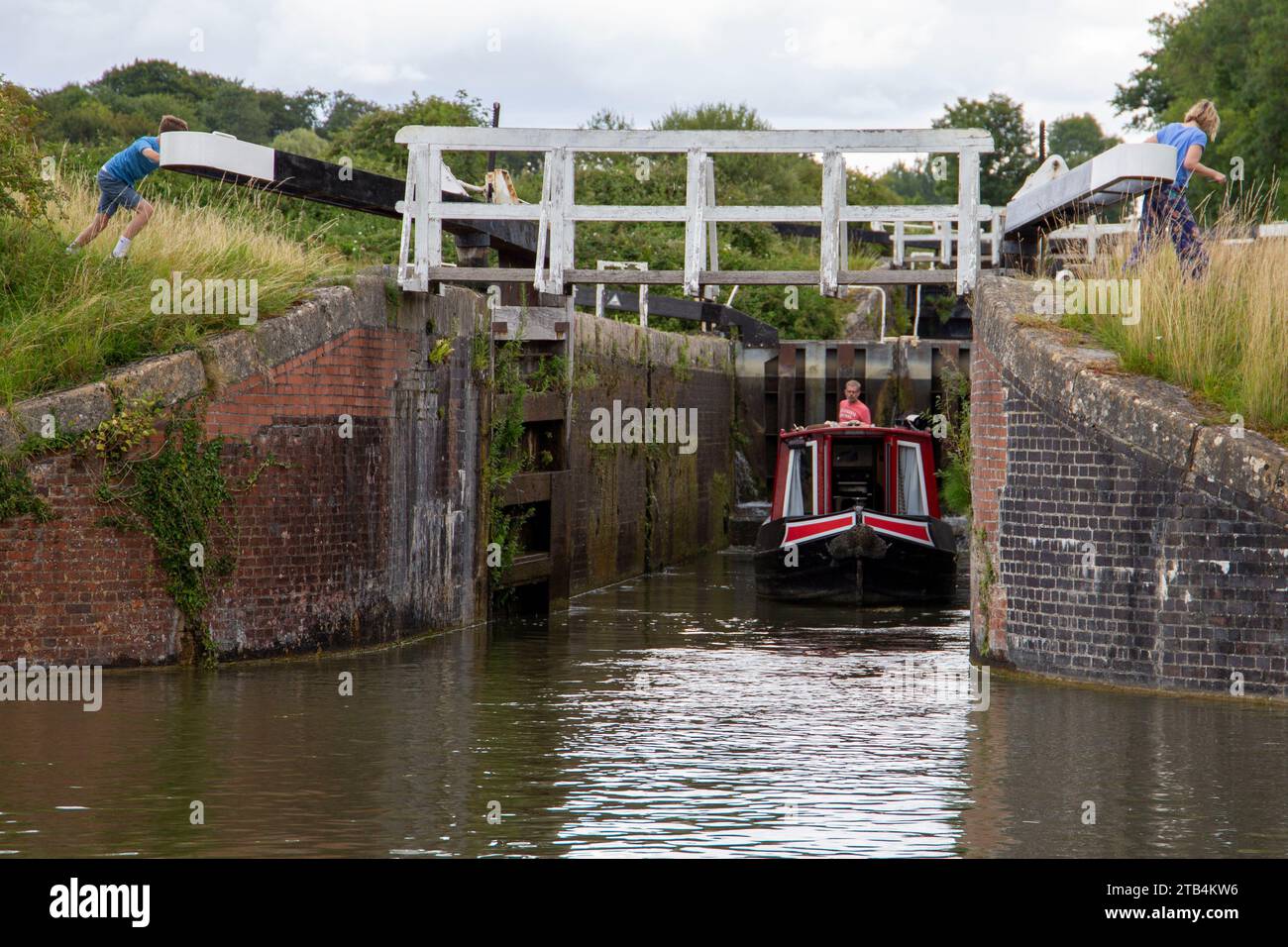 Narrowboat exiting the lower end of the Caen hill flight of 29 locks ...