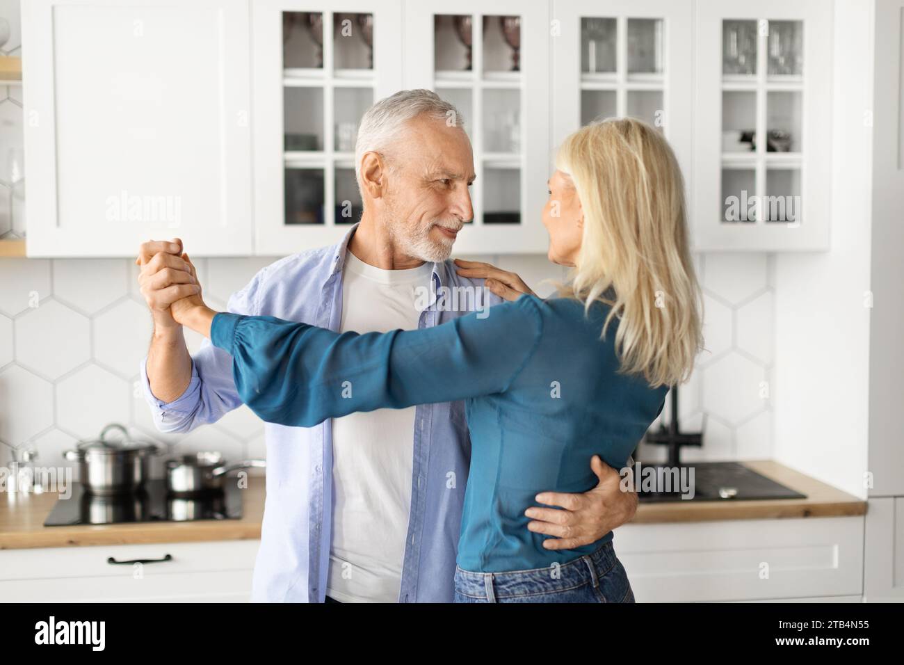 Happy Retirement. Beautiful Senior Couple Dancing In Kitchen Interior ...