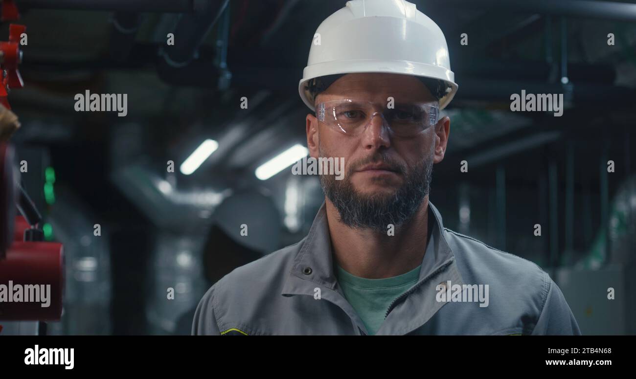 Mechanic in helmet stands plant hi-res stock photography and images - Alamy